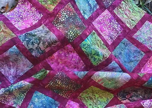 Easy Christmas Charm Square Batik Quilt Tutorial | AllFreeSewing.com